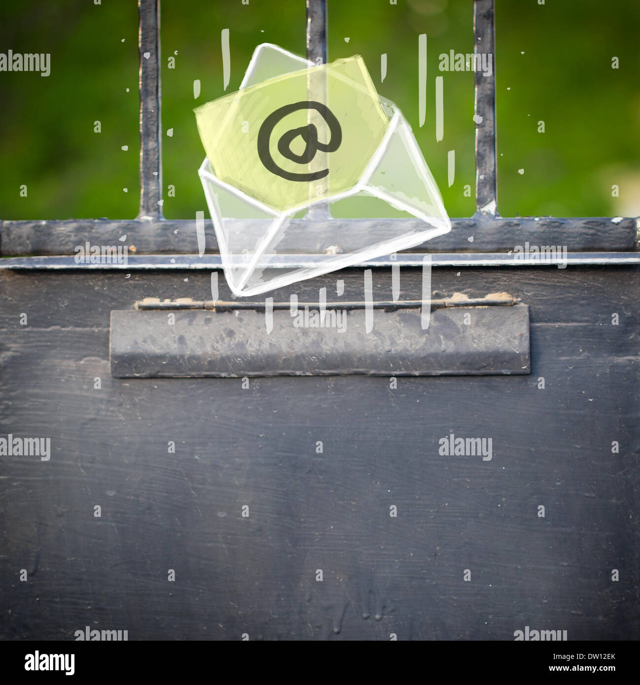 Envelope with email sign dropping into mailbox Stock Photo - Alamy