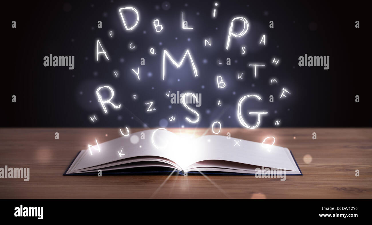 Open book with glowing letters flying out Stock Photo - Alamy