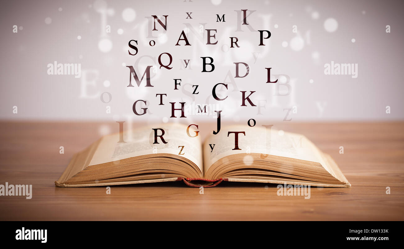 Opened book with flying letters Stock Photo - Alamy