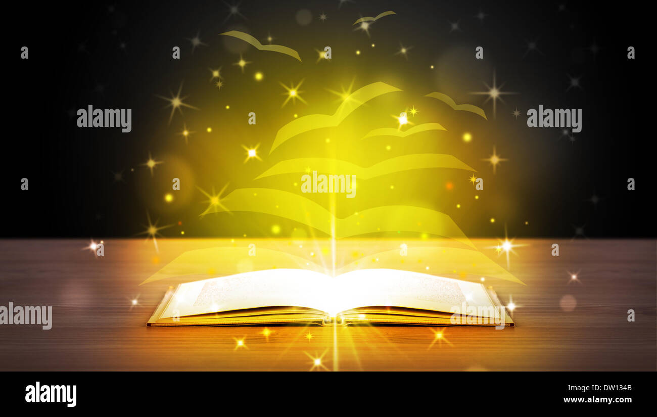 Open book with golden glow flying paper pages Stock Photo - Alamy