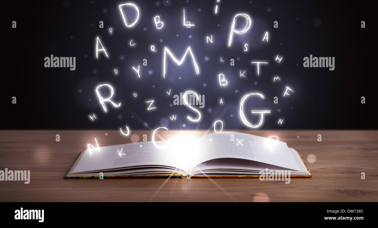 Open book with glowing letters flying out Stock Photo - Alamy