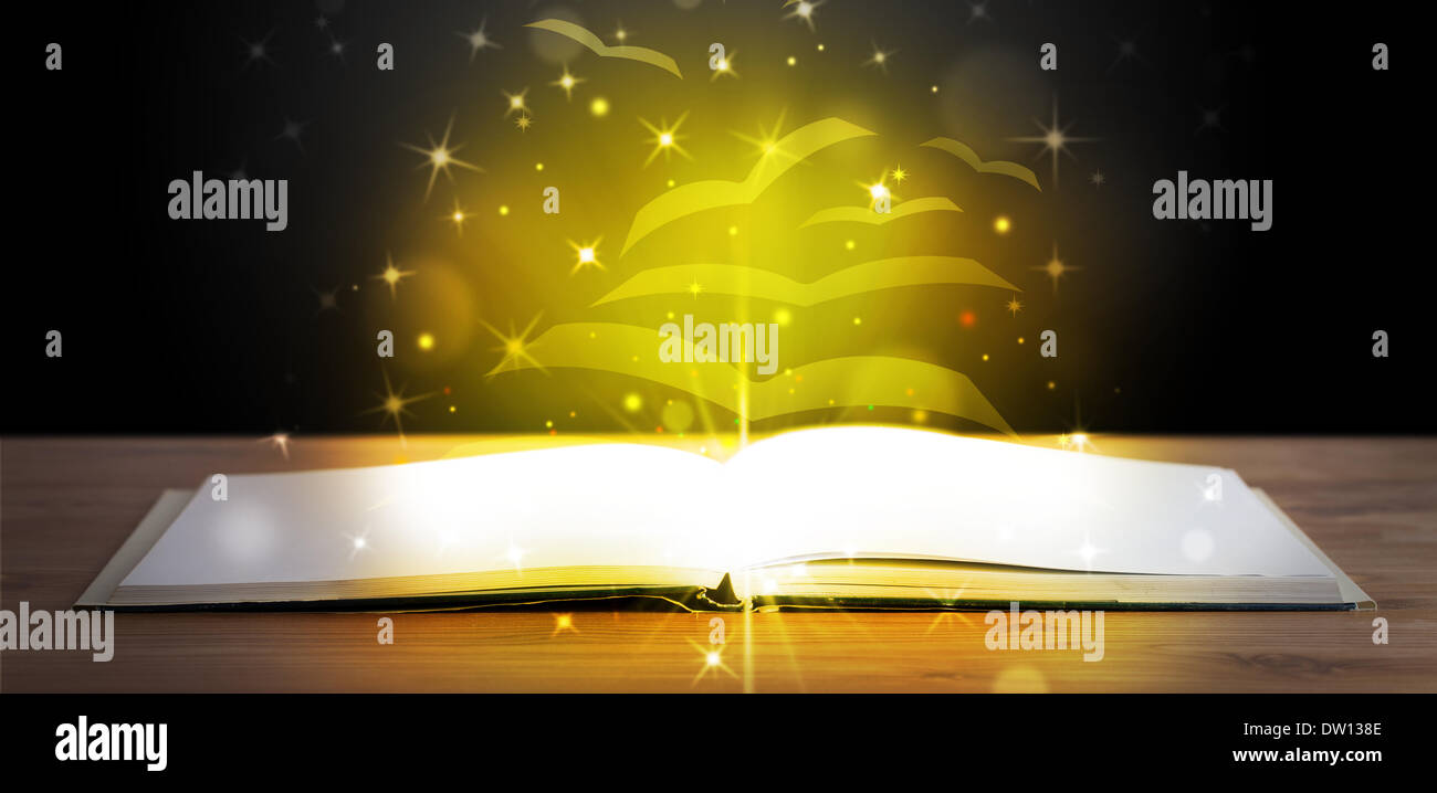 Open book with golden glow flying paper pages Stock Photo - Alamy