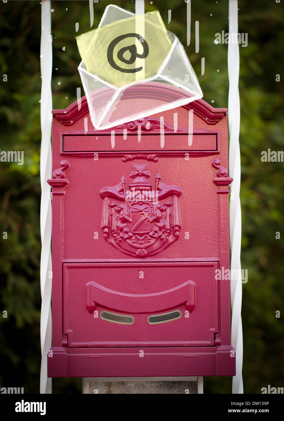 Envelope with email sign dropping into mailbox Stock Photo - Alamy