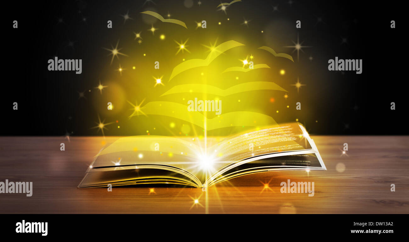 Open book with golden glow flying paper pages Stock Photo - Alamy