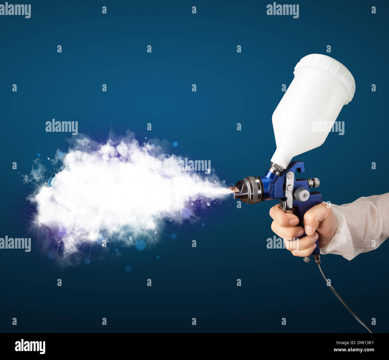 Painter with airbrush gun and white magical smoke Stock Photo - Alamy