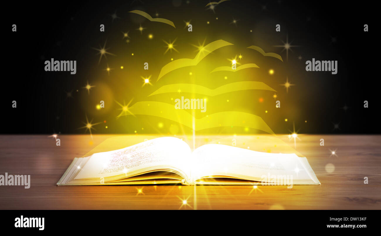 Open book with golden glow flying paper pages Stock Photo - Alamy