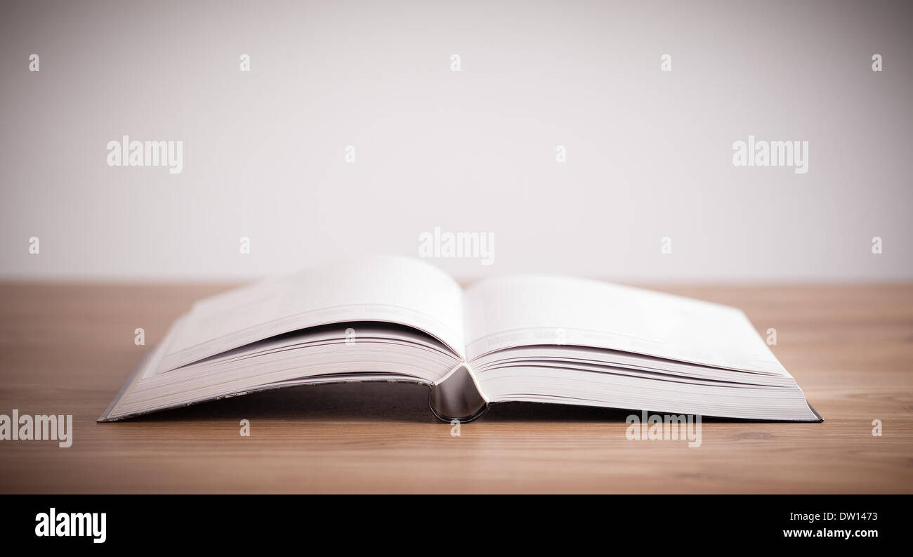 Open Book on wood background Stock Photo - Alamy