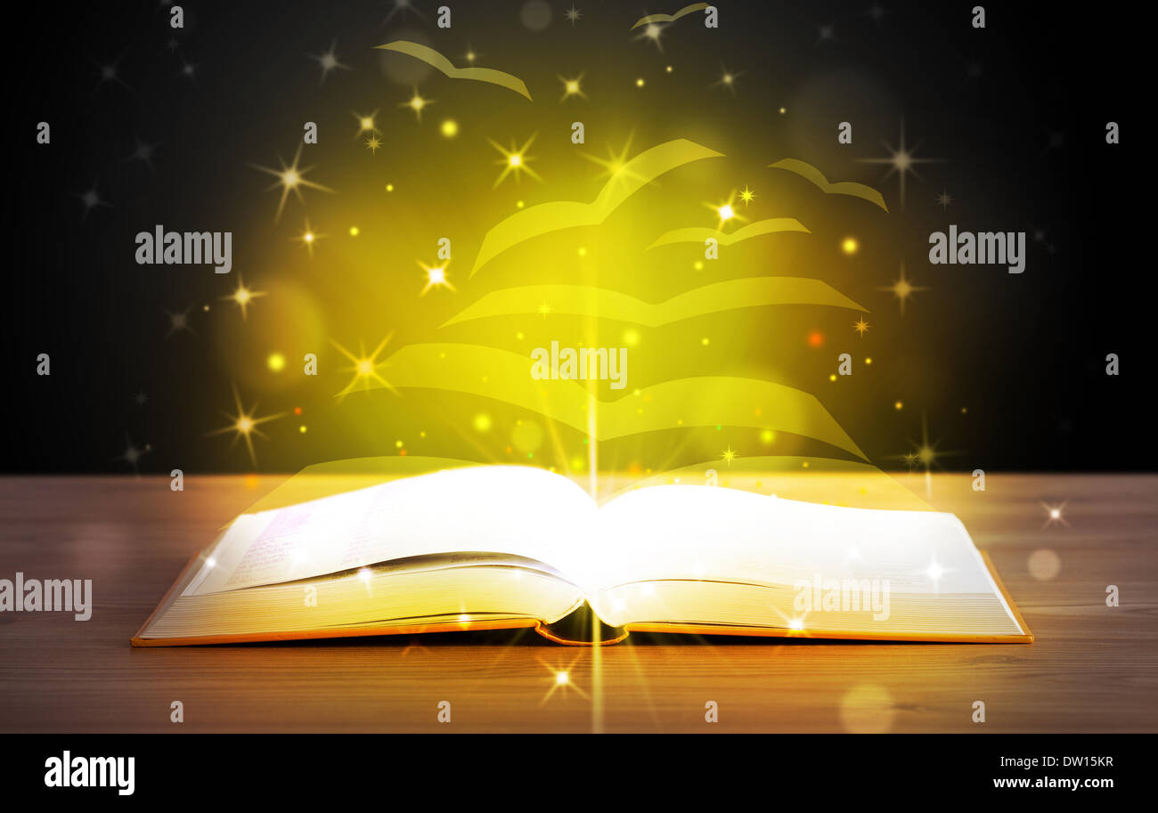 Open book with golden glow flying paper pages Stock Photo - Alamy