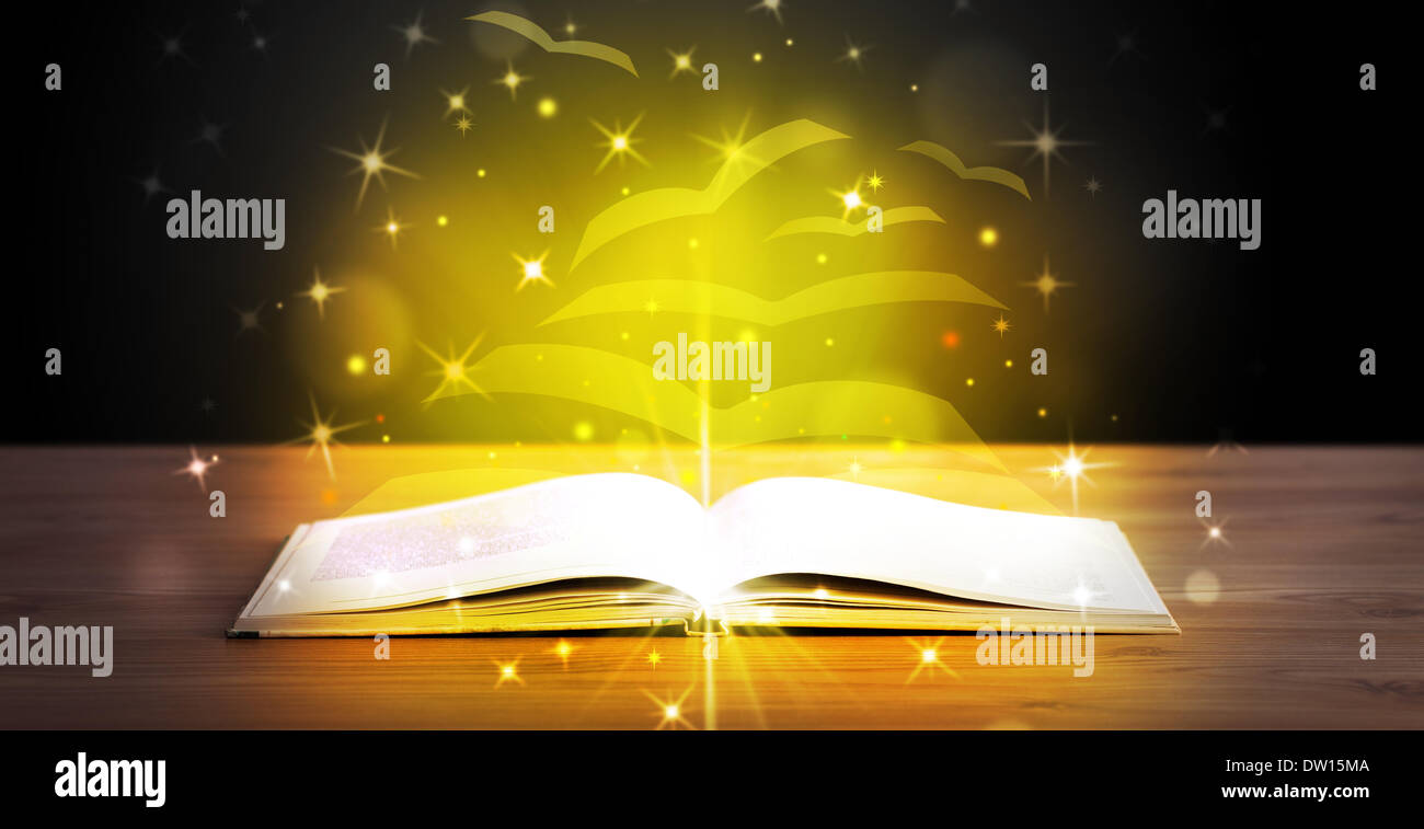 Open book with golden glow flying paper pages Stock Photo - Alamy