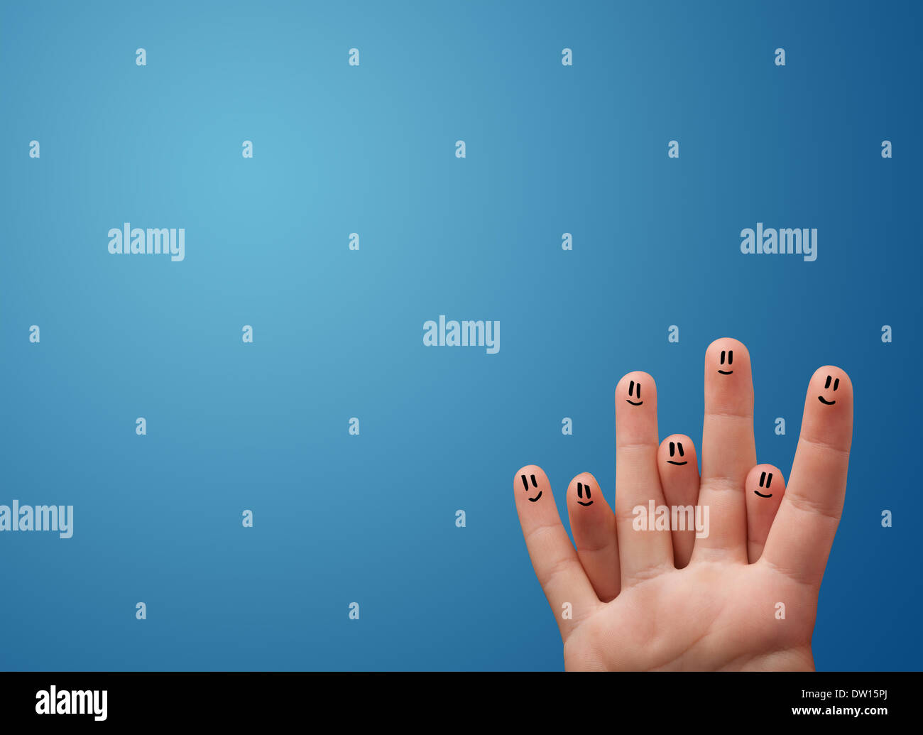 Happy smiley face fingers looking at empty blue background copy space ...