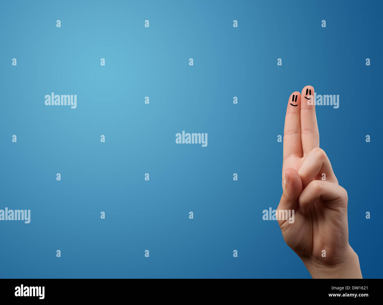 Happy smiley face fingers looking at empty blue background copy space ...