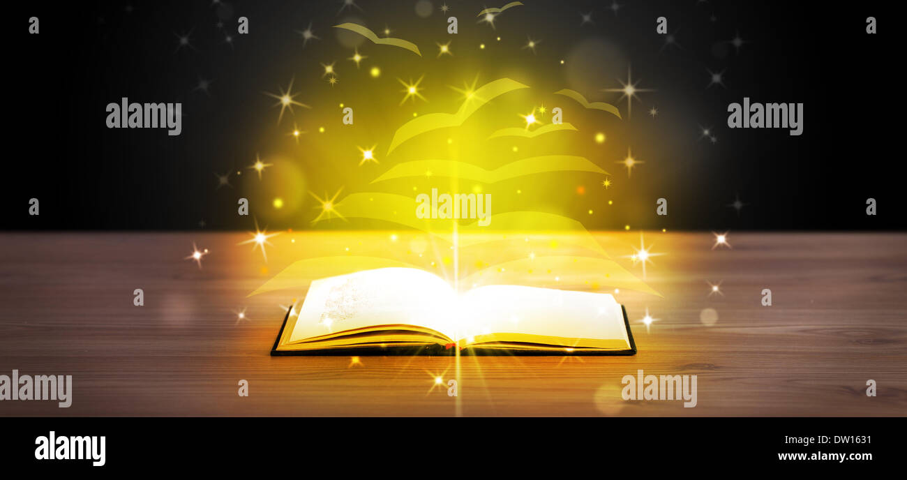 Open book with golden glow flying paper pages Stock Photo - Alamy