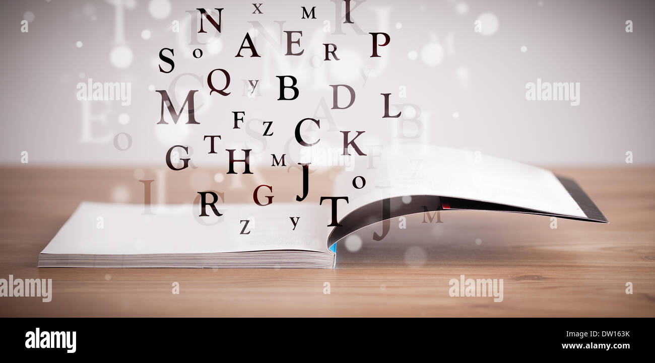 Opened book with flying letters Stock Photo - Alamy