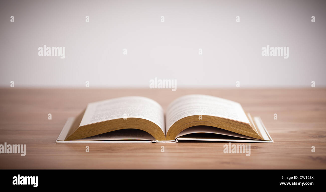 Open Book on wood background Stock Photo - Alamy