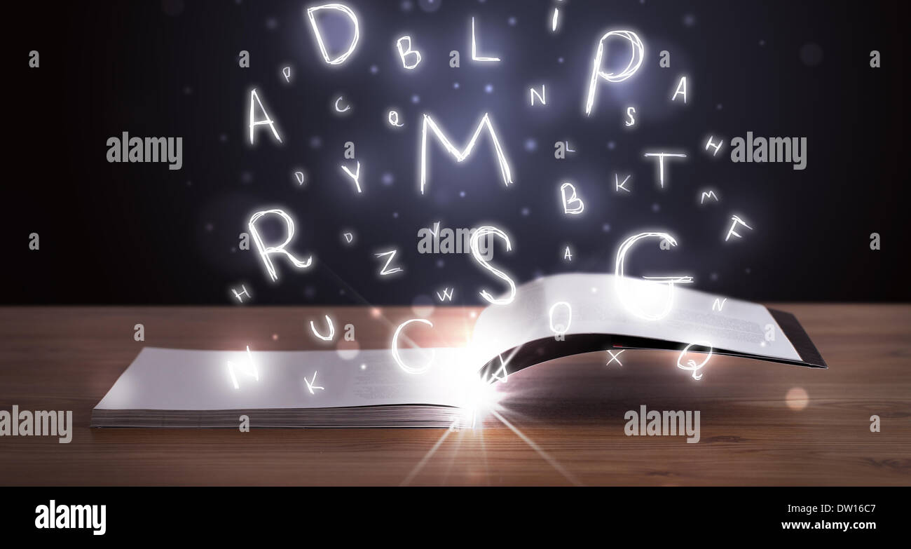 Open book with glowing letters flying out Stock Photo - Alamy