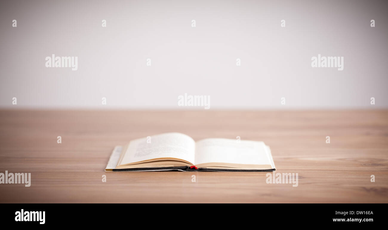 Open Book on wood background Stock Photo - Alamy