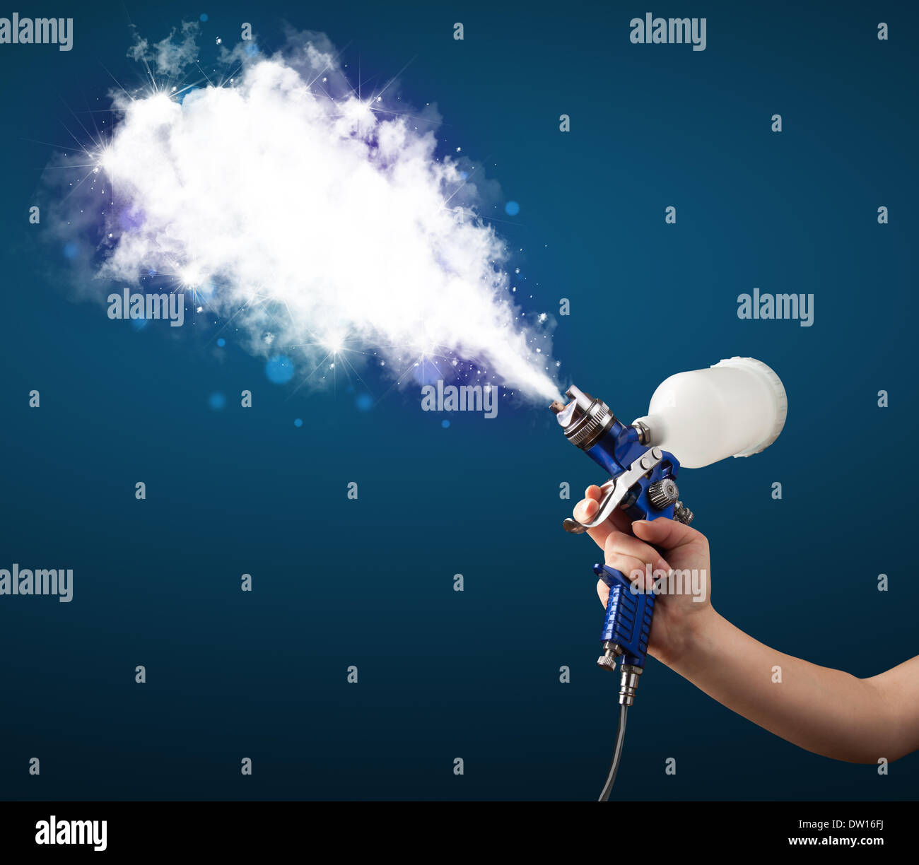 Painter with airbrush gun and white magical smoke Stock Photo - Alamy