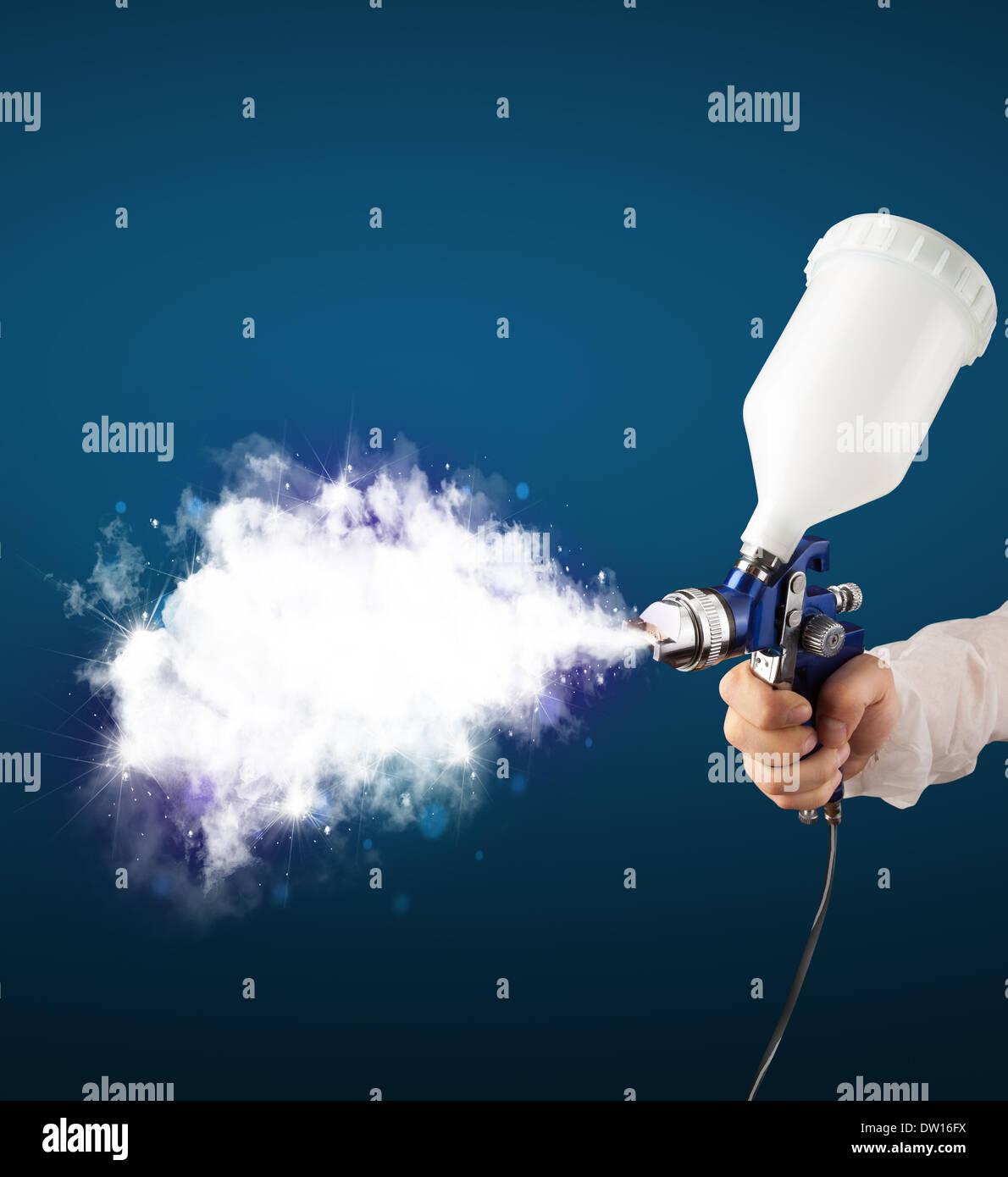 Painter with airbrush gun and white magical smoke Stock Photo - Alamy