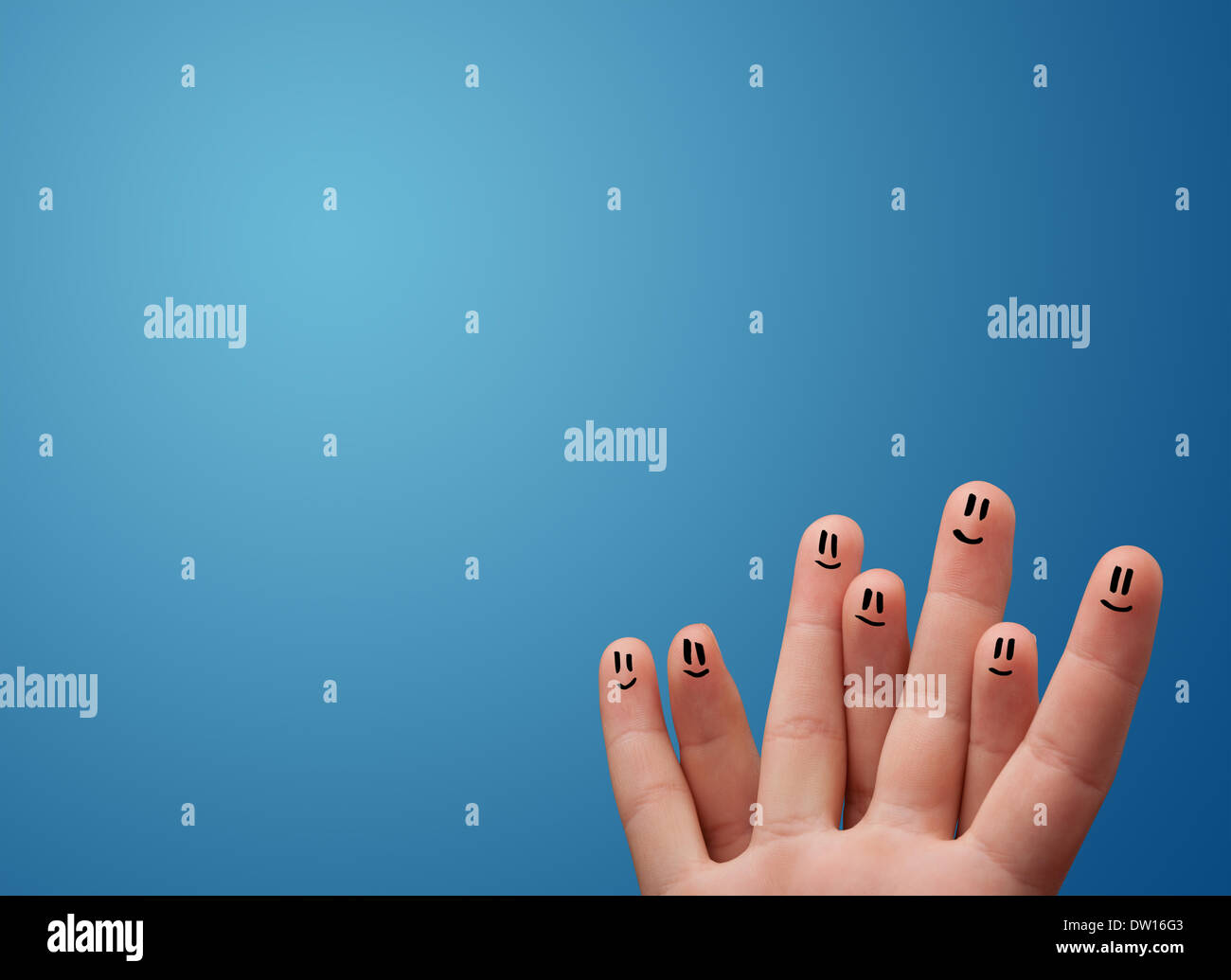 Happy smiley face fingers looking at empty blue background copy space ...