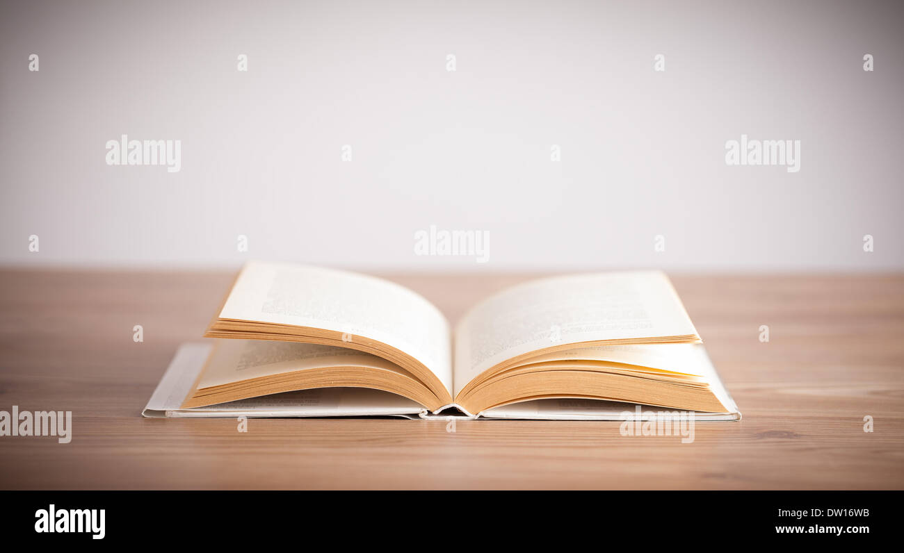 Open Book on wood background Stock Photo - Alamy