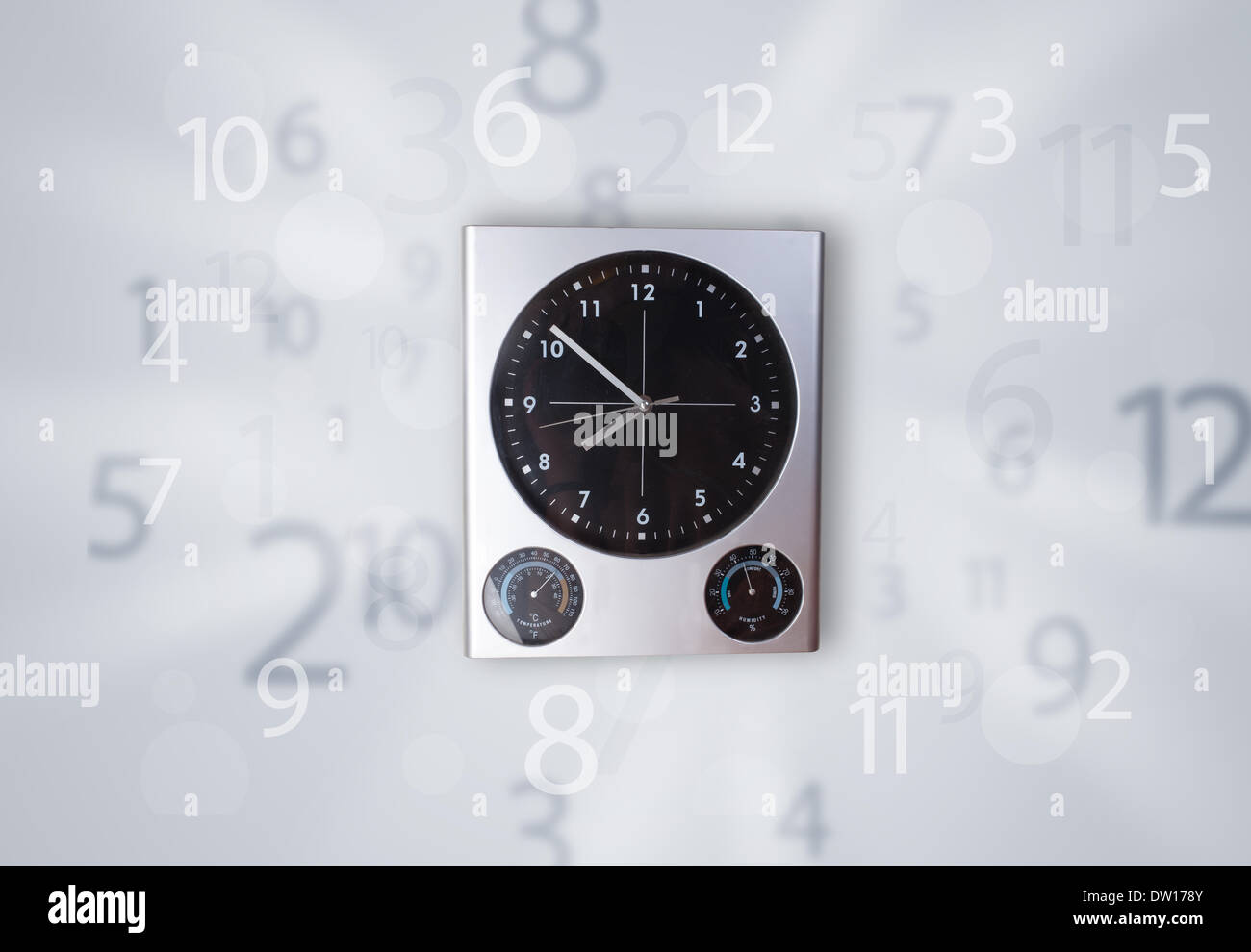 Modern clock with numbers comming out Stock Photo - Alamy