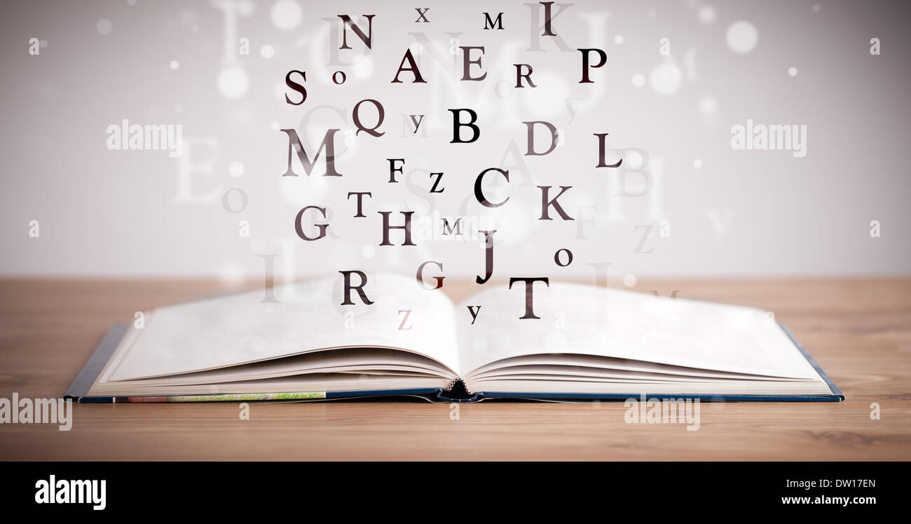 Opened book with flying letters Stock Photo - Alamy