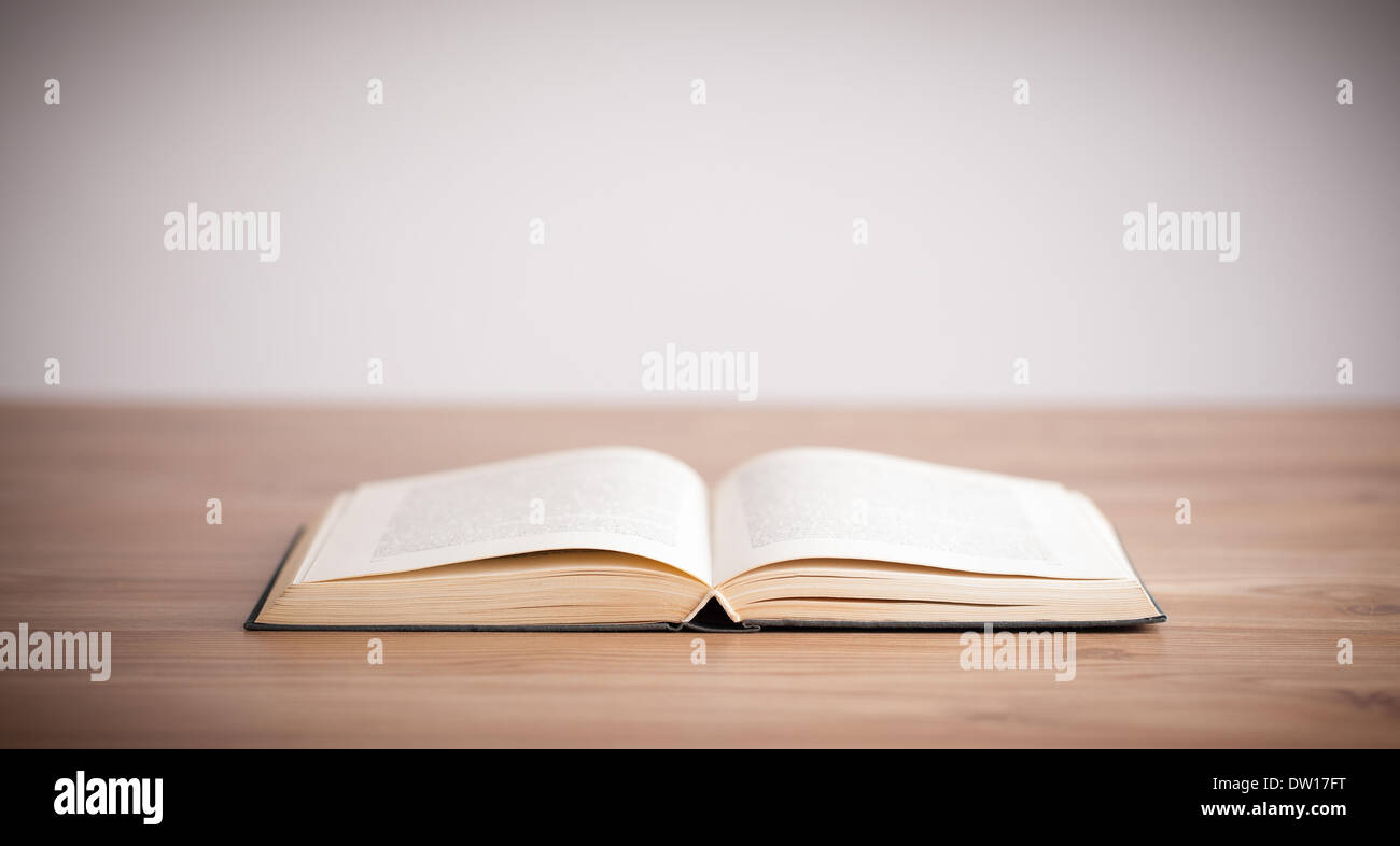 Open Book on wood background Stock Photo - Alamy