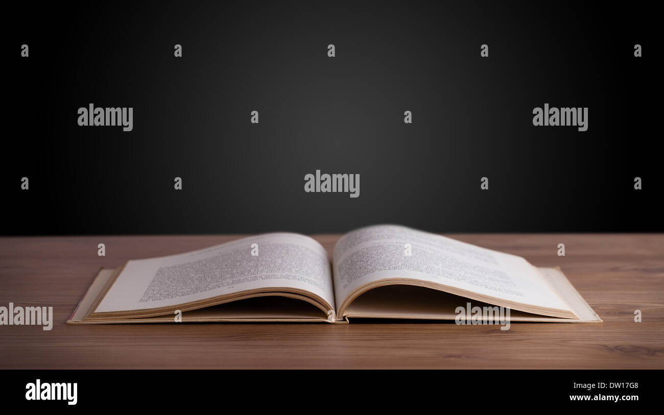 Open book on wooden deck Stock Photo - Alamy
