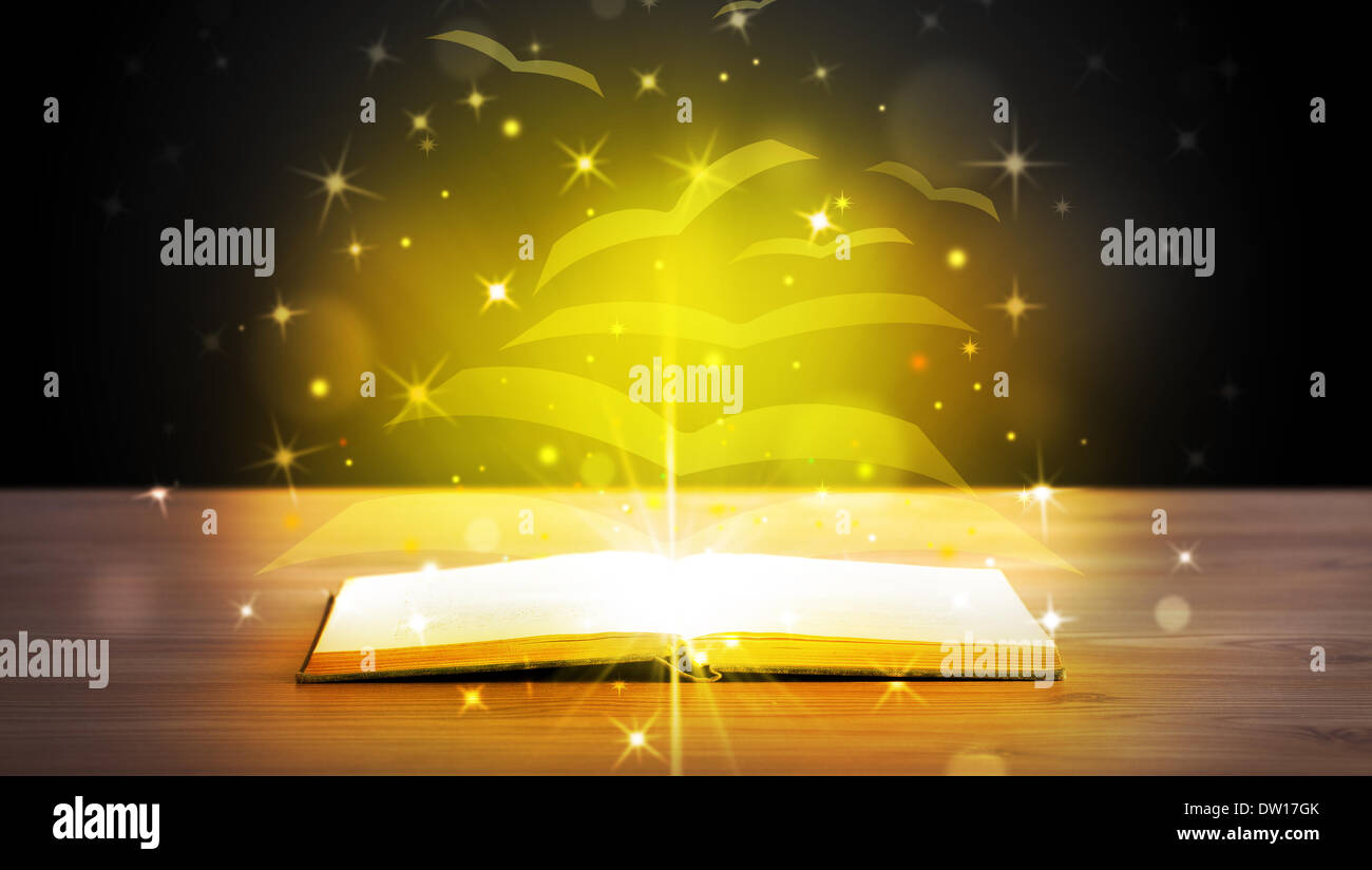Open book with golden glow flying paper pages Stock Photo - Alamy