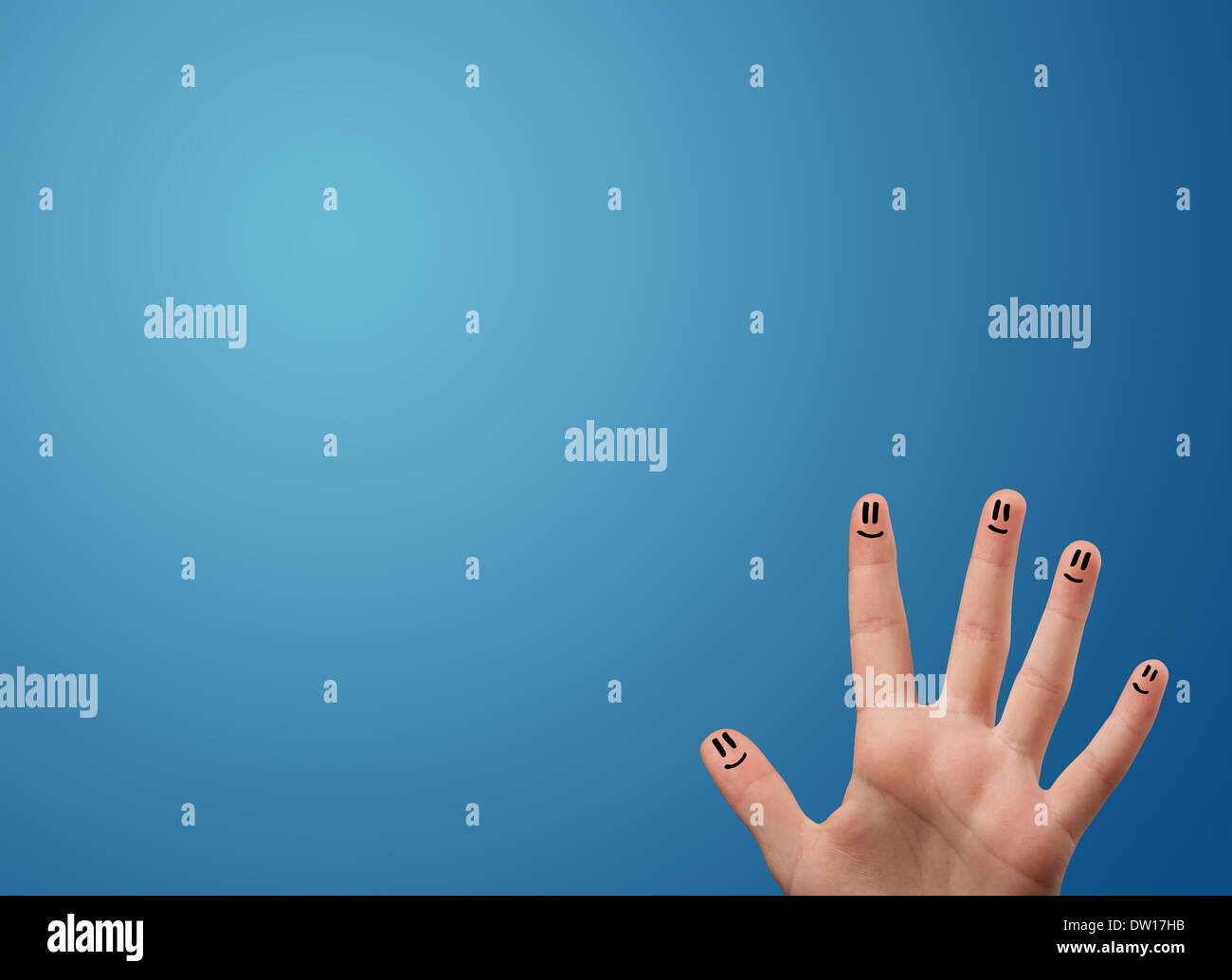 Happy smiley face fingers looking at empty blue background copy space ...