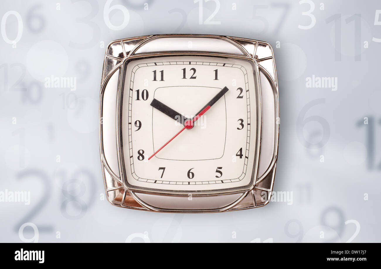 Modern clock with numbers comming out Stock Photo - Alamy