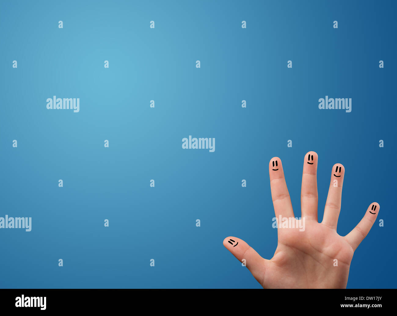 Happy smiley face fingers looking at empty blue background copy space ...