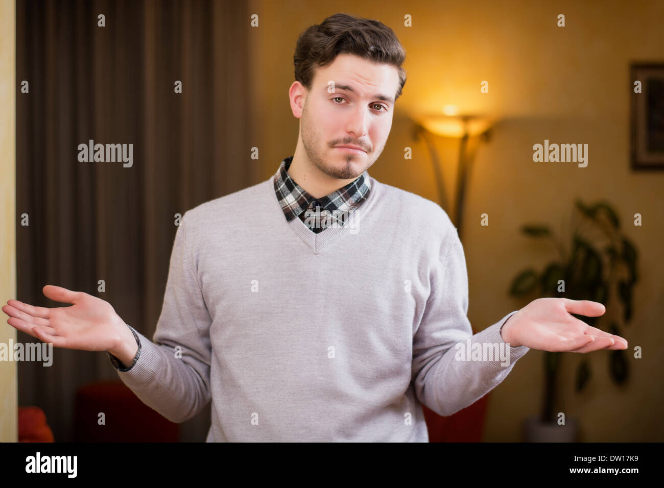 Confused young man standing in hi-res stock photography and images - Alamy