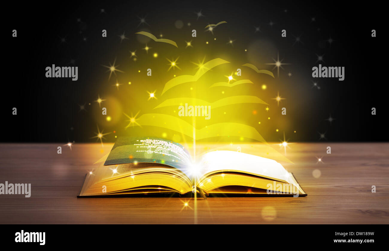 Open book with golden glow flying paper pages Stock Photo - Alamy