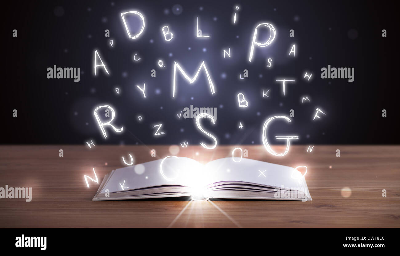 Open book with glowing letters flying out Stock Photo - Alamy