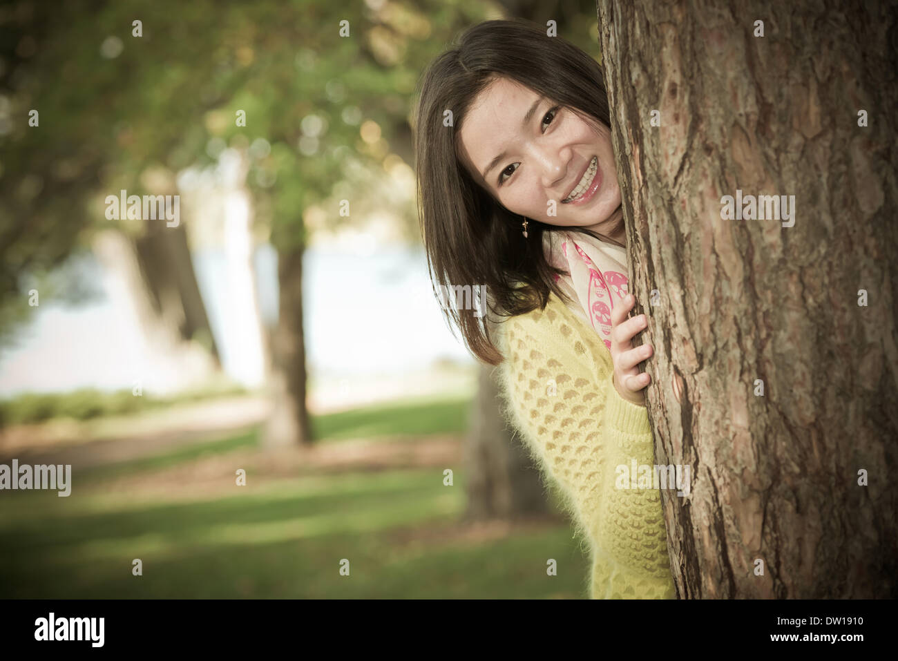 Scared Girl Hiding Behind Tree