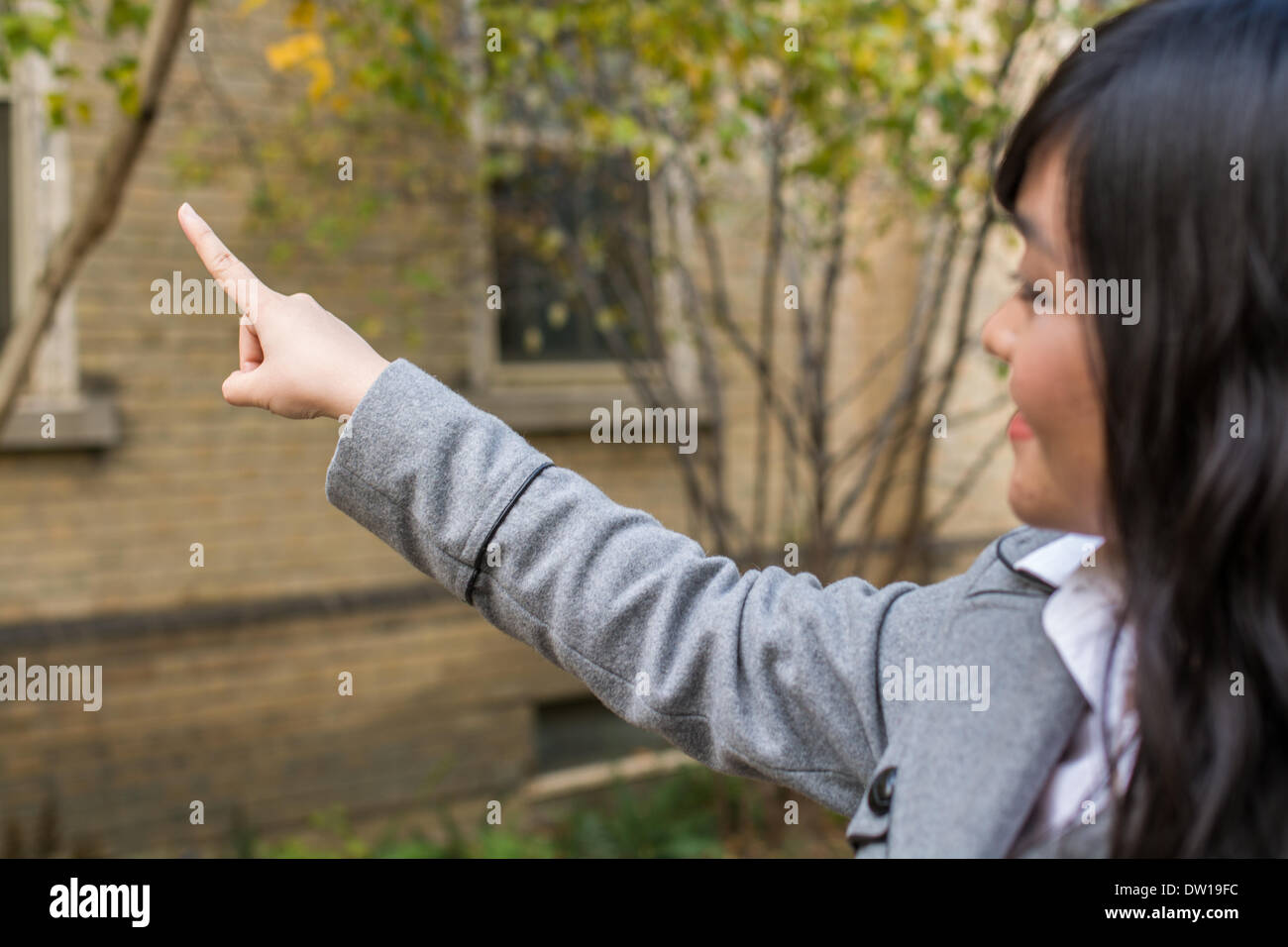 Portrait of woman pointing at something Stock Photo - Alamy
