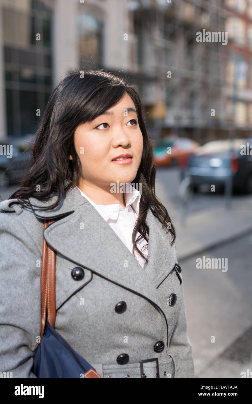 Woman on busy street Stock Photo - Alamy