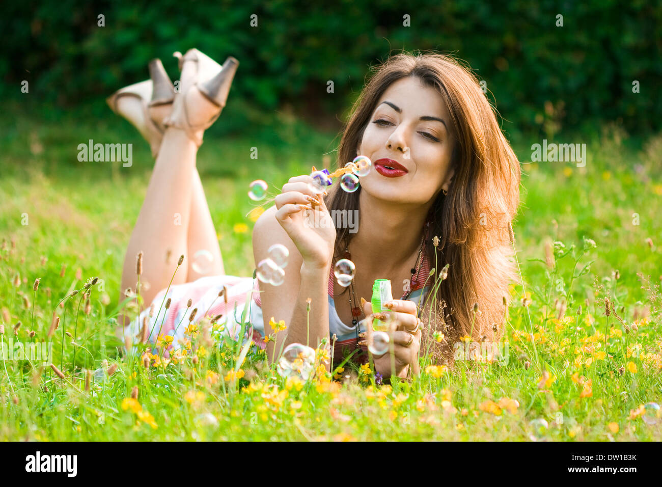 girl inflating soap-bubbles in field Stock Photo - Alamy