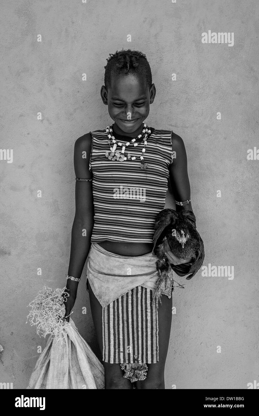 A Child From The Banna Tribe In Traditional Costume On Her Way To ...