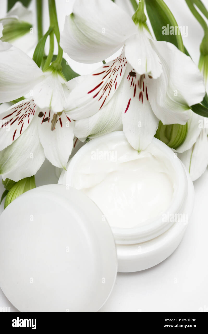 cosmetic moisturizing cream with flowers Stock Photo - Alamy