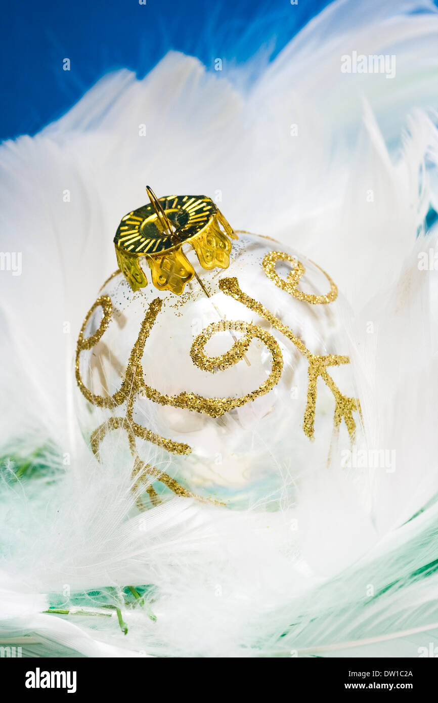 Christmas ball on white feather Stock Photo - Alamy