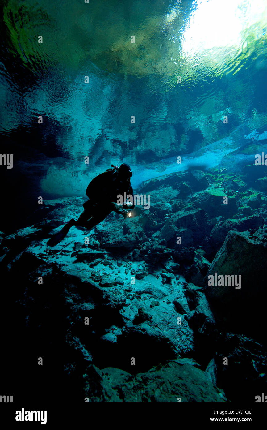 Scuba diver swimming thru the underwater Chikin Ha Cenote cave, Yucatan ...