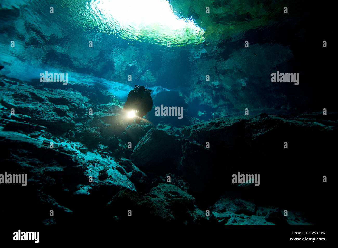 Scuba diver swimming thru the underwater Chikin Ha Cenote cave, Yucatan ...