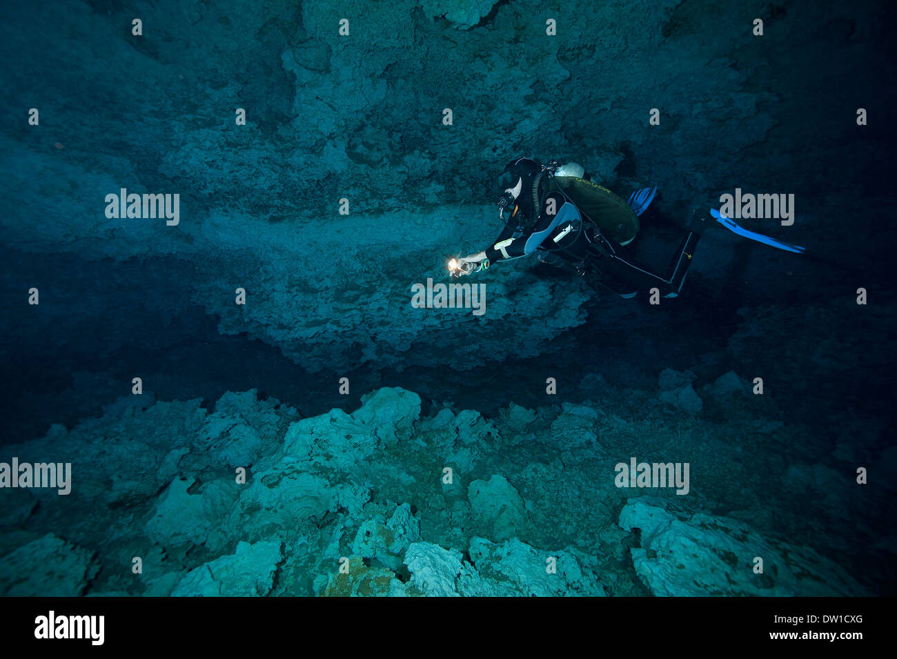 Scuba diver swimming thru the underwater Chikin Ha Cenote cave, Yucatan ...