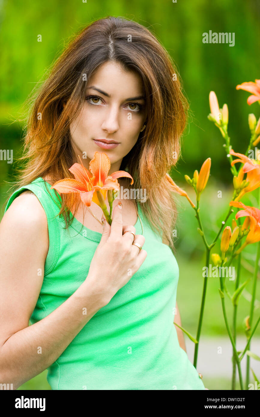 Beautiful woman in garden with flowers Stock Photo - Alamy