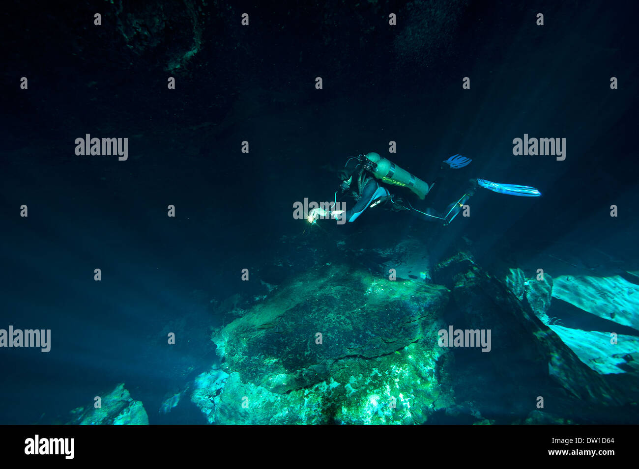 Scuba diver swimming thru the underwater Kulukan Cenote cave, Yucatan ...