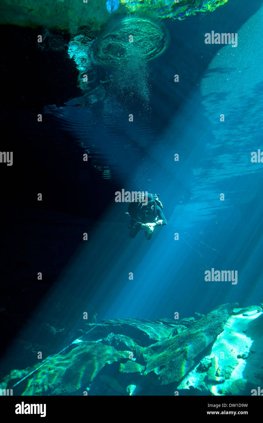 Scuba diver swimming thru the underwater Kulukan Cenote cave, Yucatan ...
