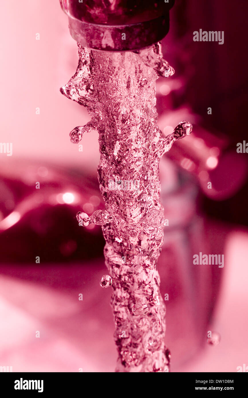 water running down from faucet in red color Stock Photo - Alamy