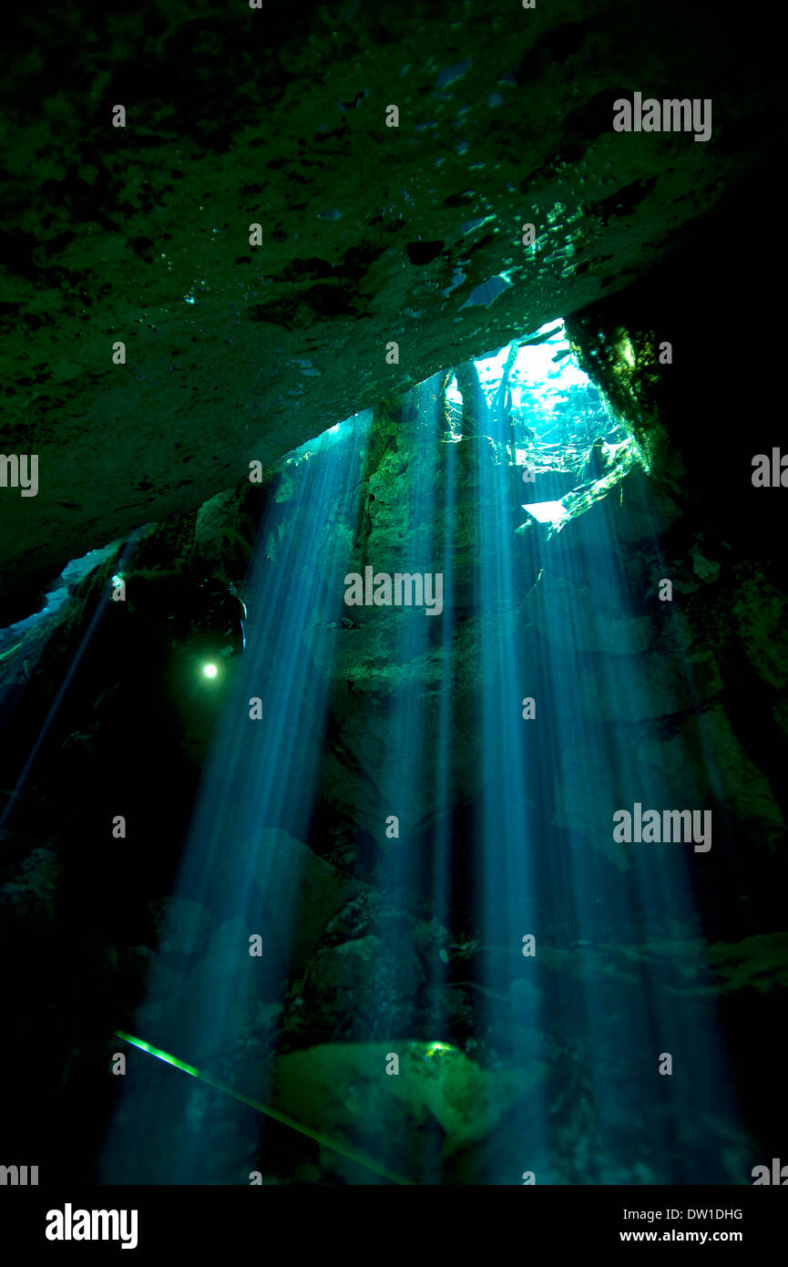 Scuba diver swimming thru the underwater Kulukan Cenote cave, Yucatan ...